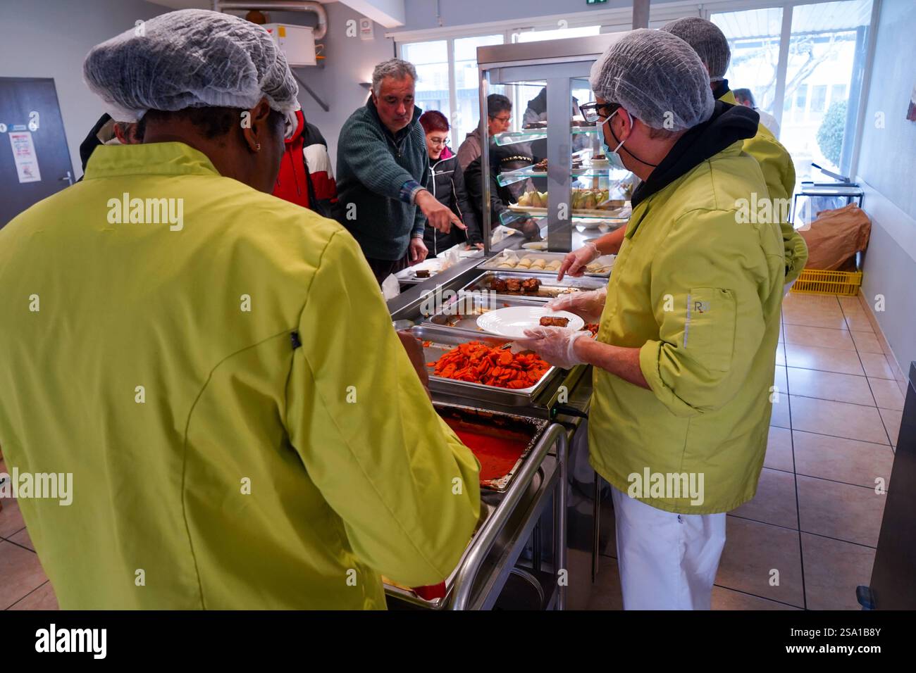 Disabled workers preparing meals for users and supervisors of the ESAT ...