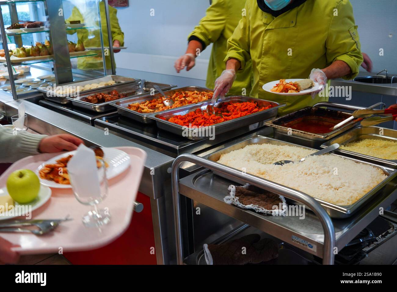 Disabled workers preparing meals for users and supervisors of the ESAT ...
