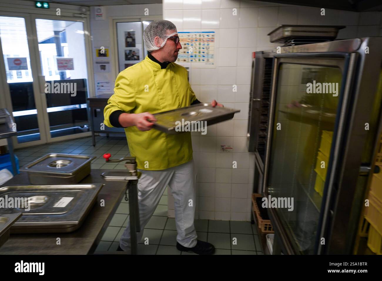 Disabled worker preparing meals for users and supervisors of the ESAT ...