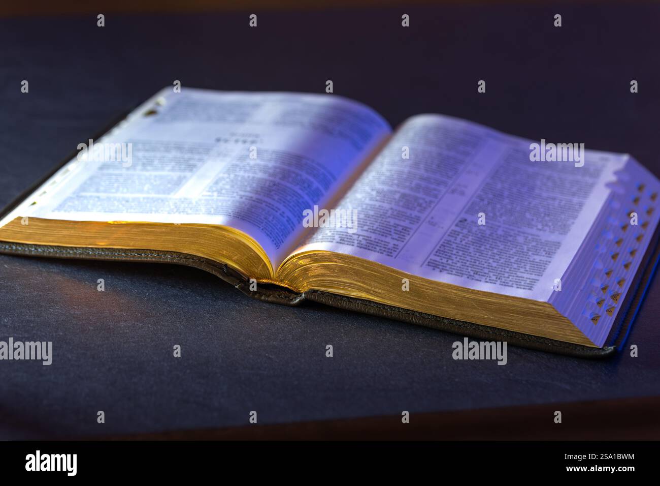 Open Holy Bible on the table. Religion concept. Bible on black ...