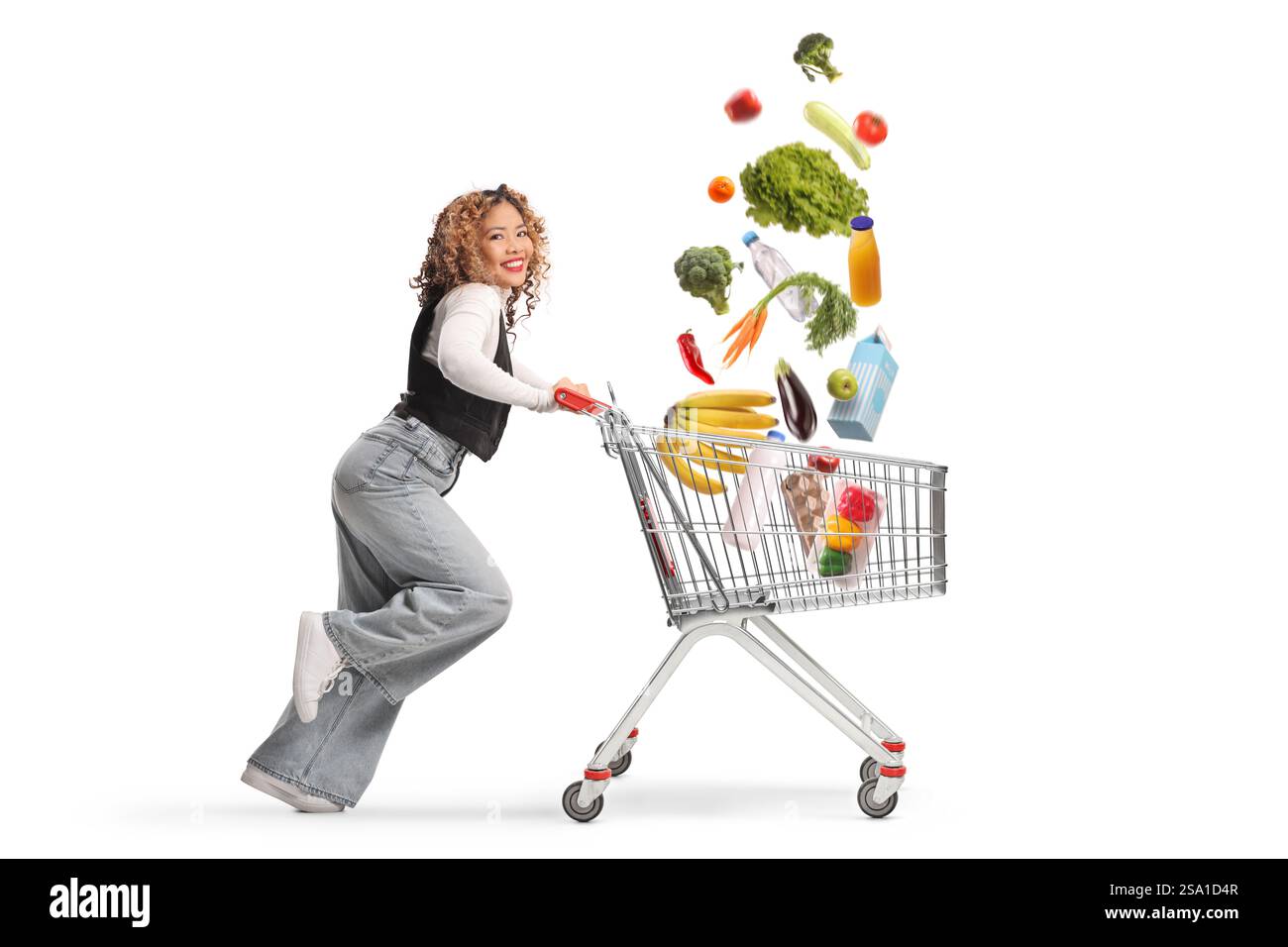 Asian woman running with a shopping cart and falling groceries isolated ...