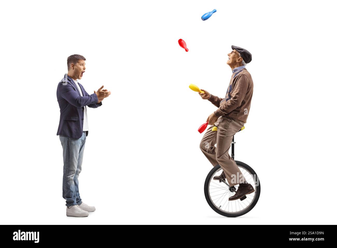 Amazed man clapping and watching an elderly man juggling on a mono ...