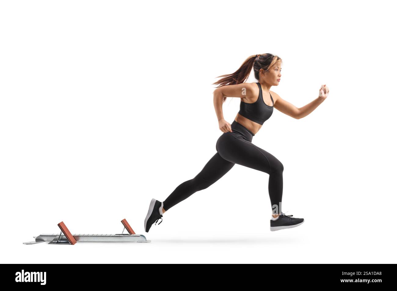 Full length profile shot of a young asian female running from starting ...