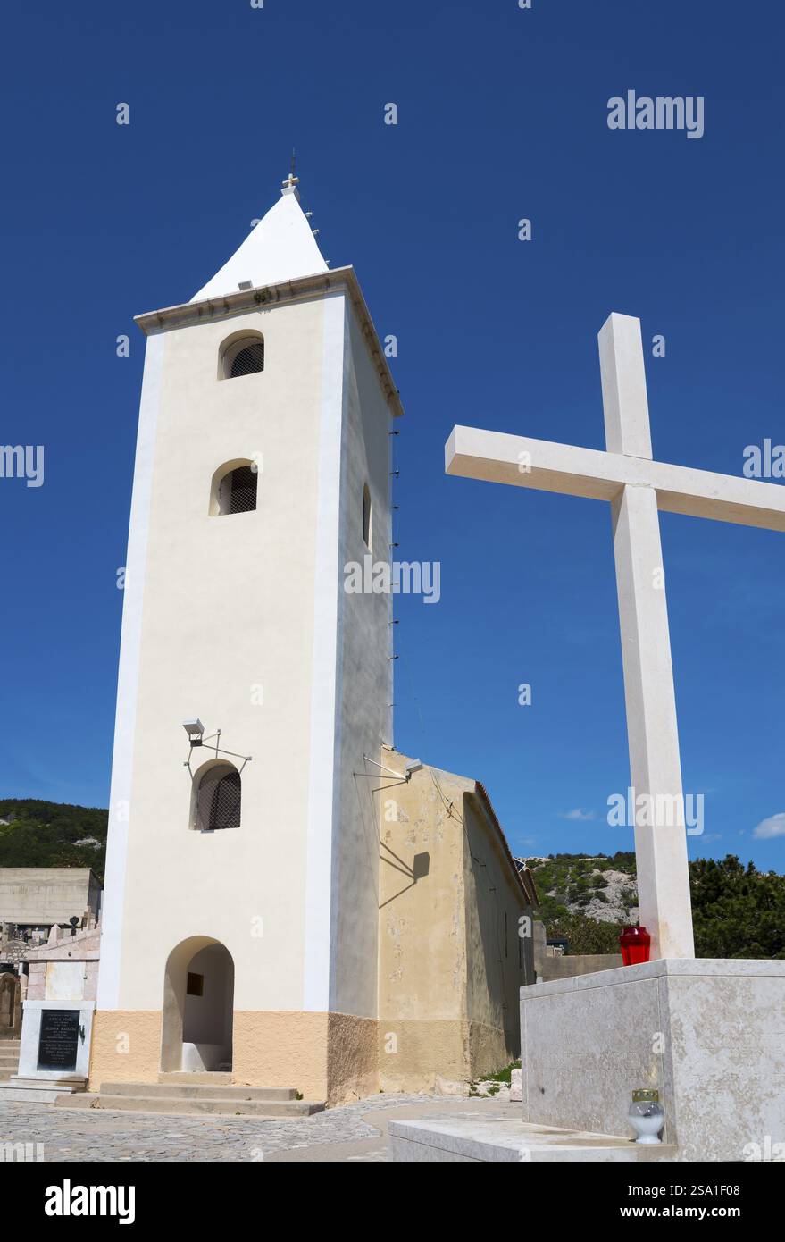 High church tower next to large cross, sunny day, historical buildings ...