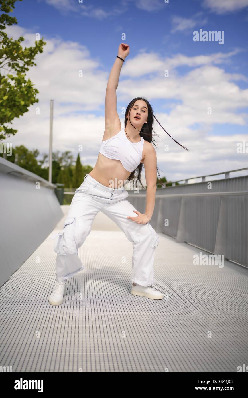 Vertical photo of a caucasian yung urban woman performing dancehall on ...