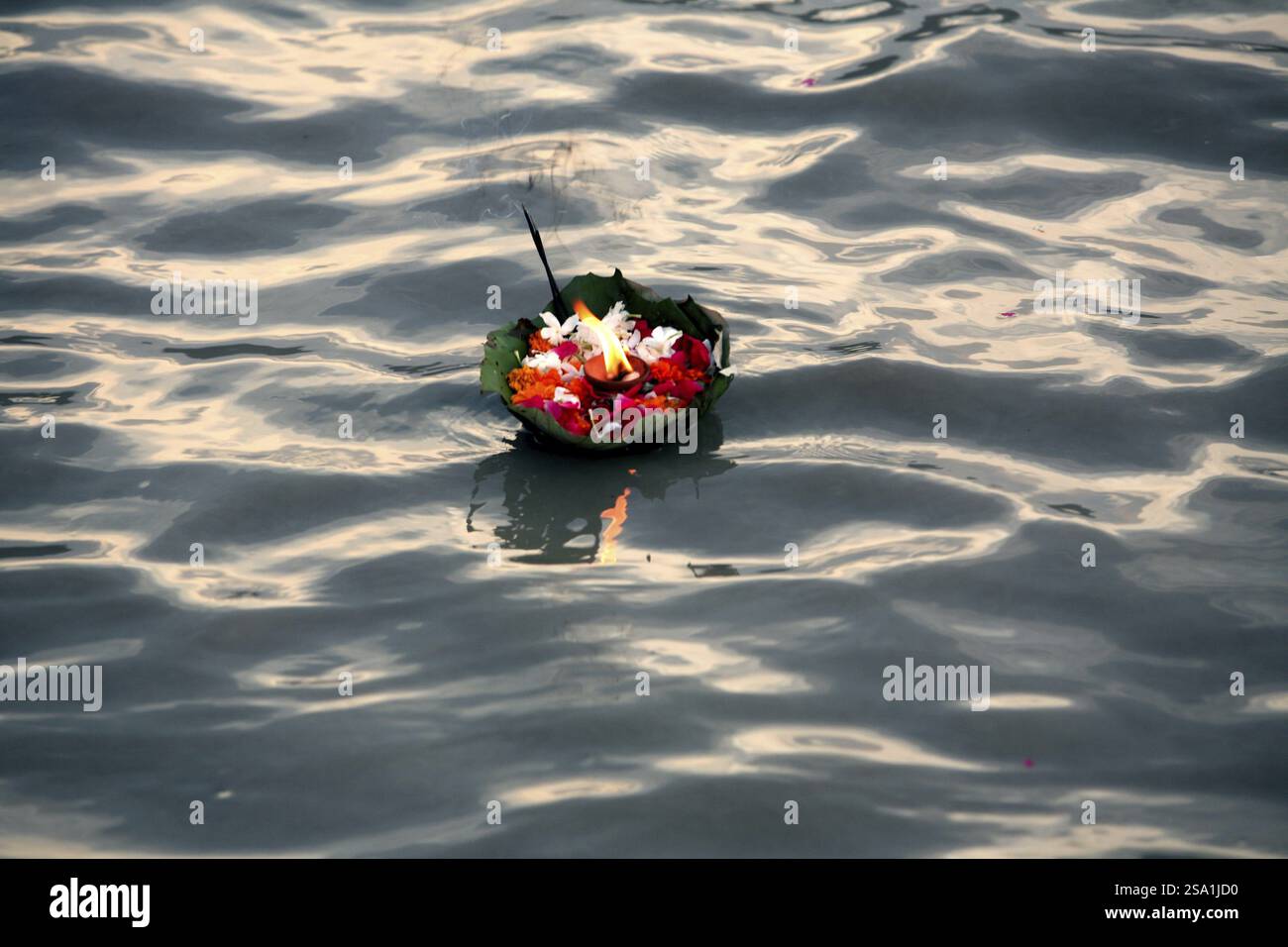 Holy offering of flowers with agarbatti and diya in Ganga river ...