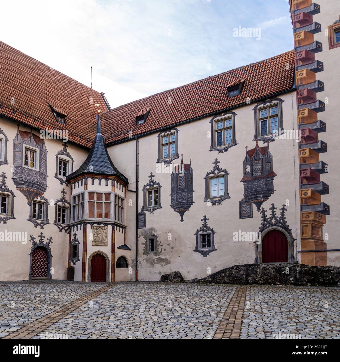 A picturesque courtyard of a historic castle featuring ornate ...
