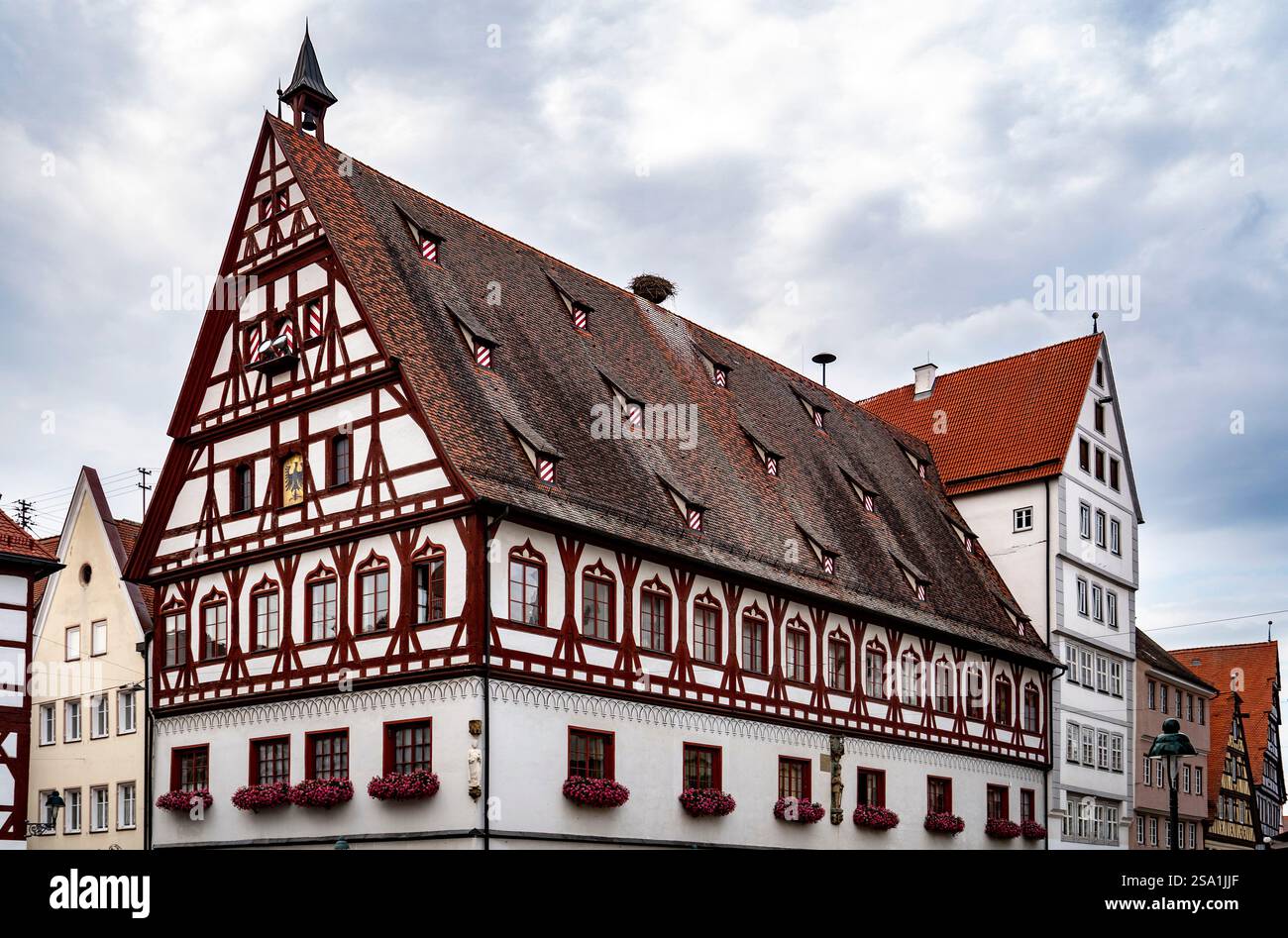 A picturesque half-timbered building with a steep roof, adorned with ...