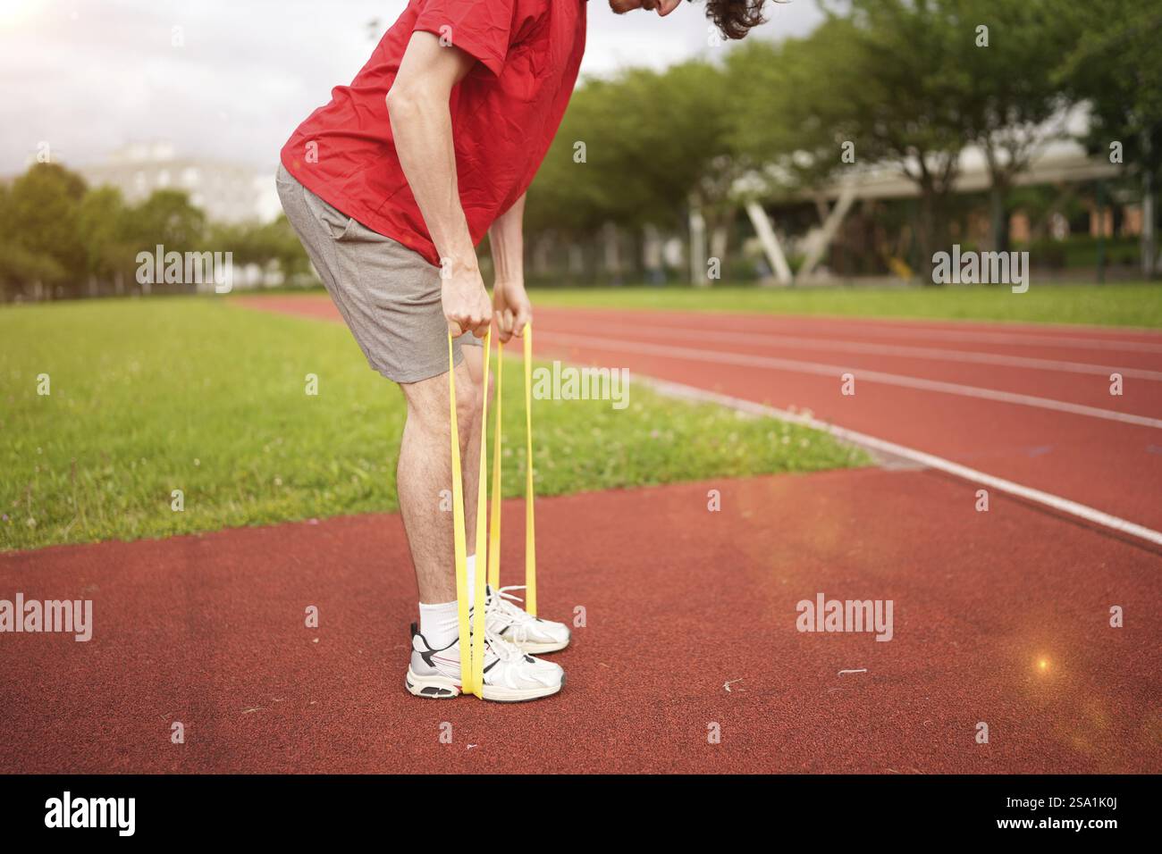 Lower section of an unrecognizable caucasian sportive young man warming ...