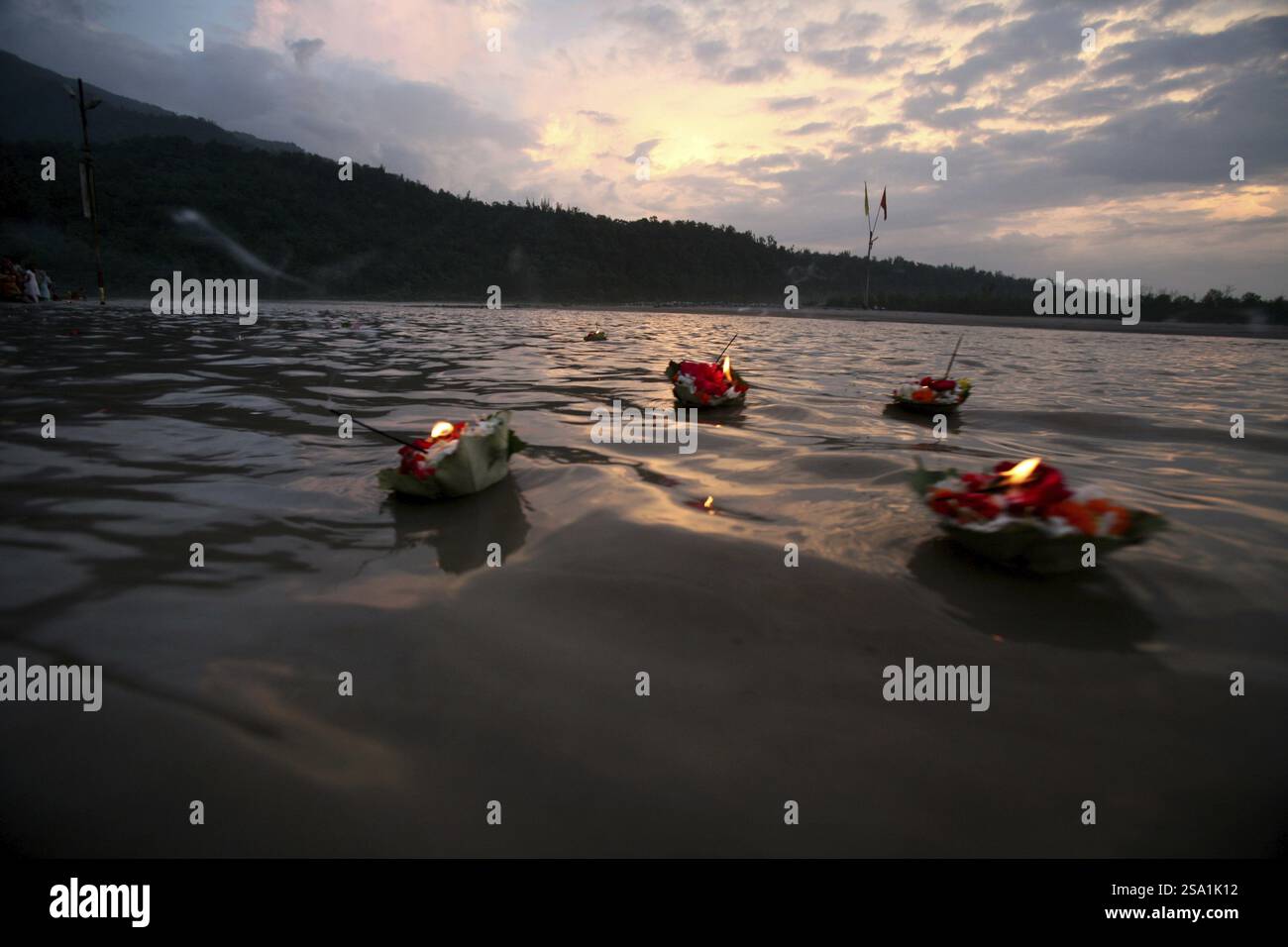 Holy offering of flowers with agarbatti and diya in Ganga river ...