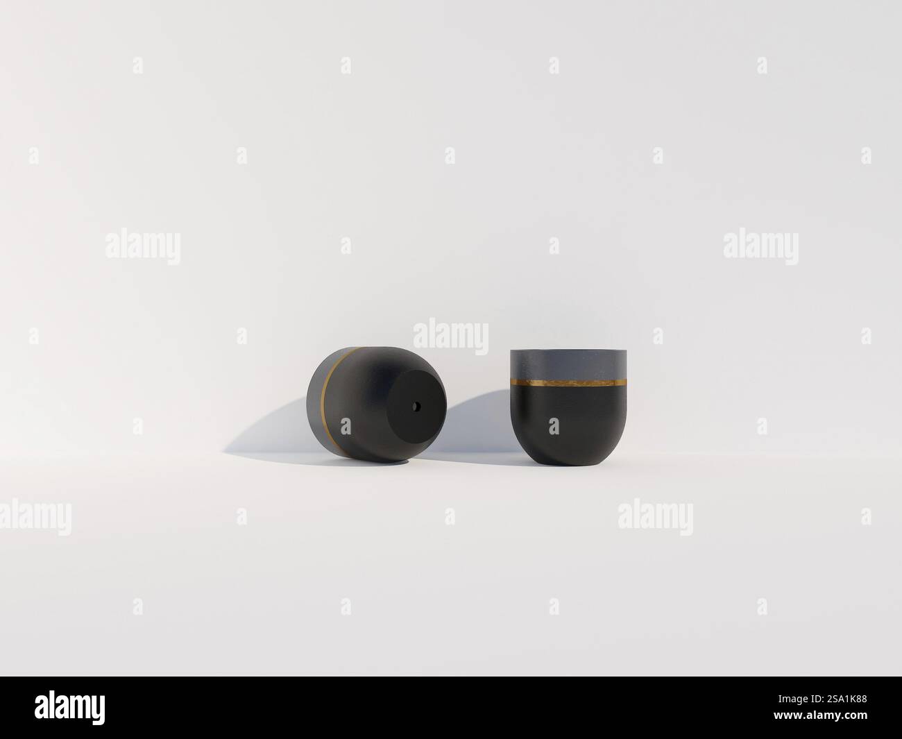 Two minimalist pottery objects in black with gold accents set against a ...