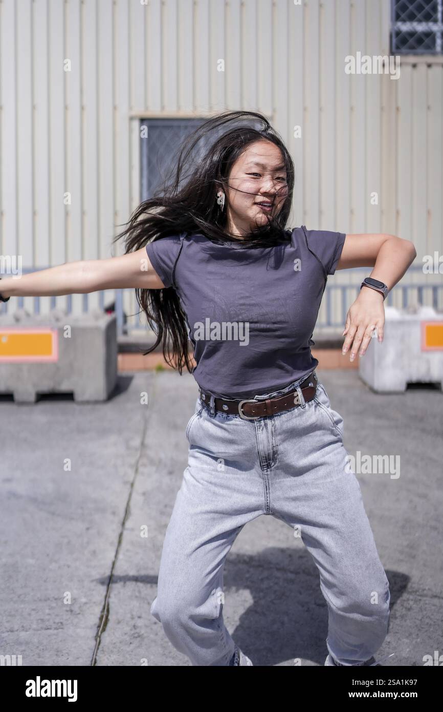 Vertical photo of a beauty female asian dancer moving arms in a ...
