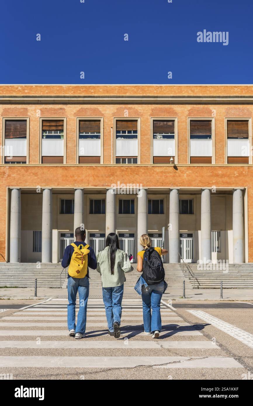 Vertical photo full length with copy space of three multi-ethnic ...