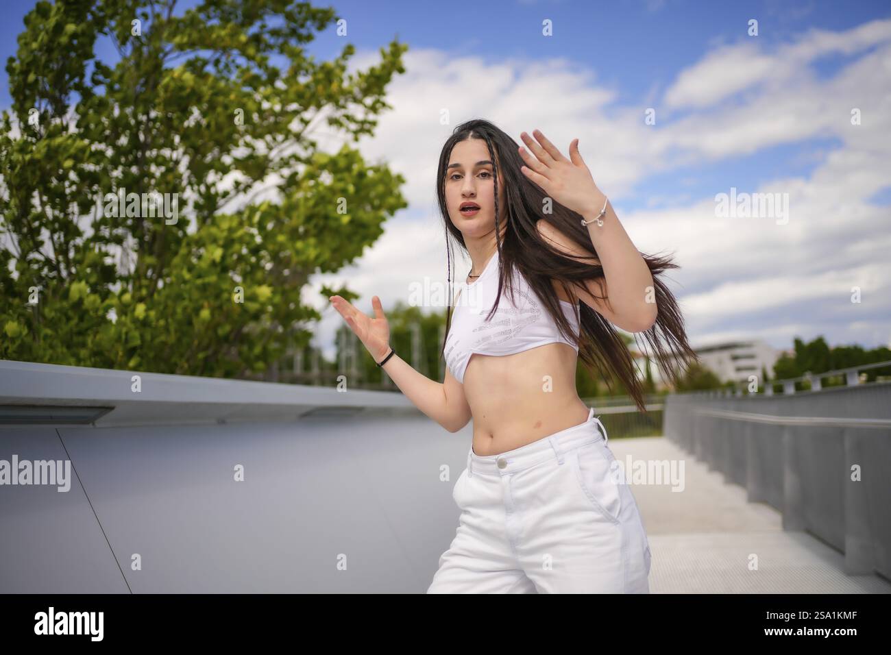 Vital beauty caucasian young woman dancing freestyle in an urban park ...
