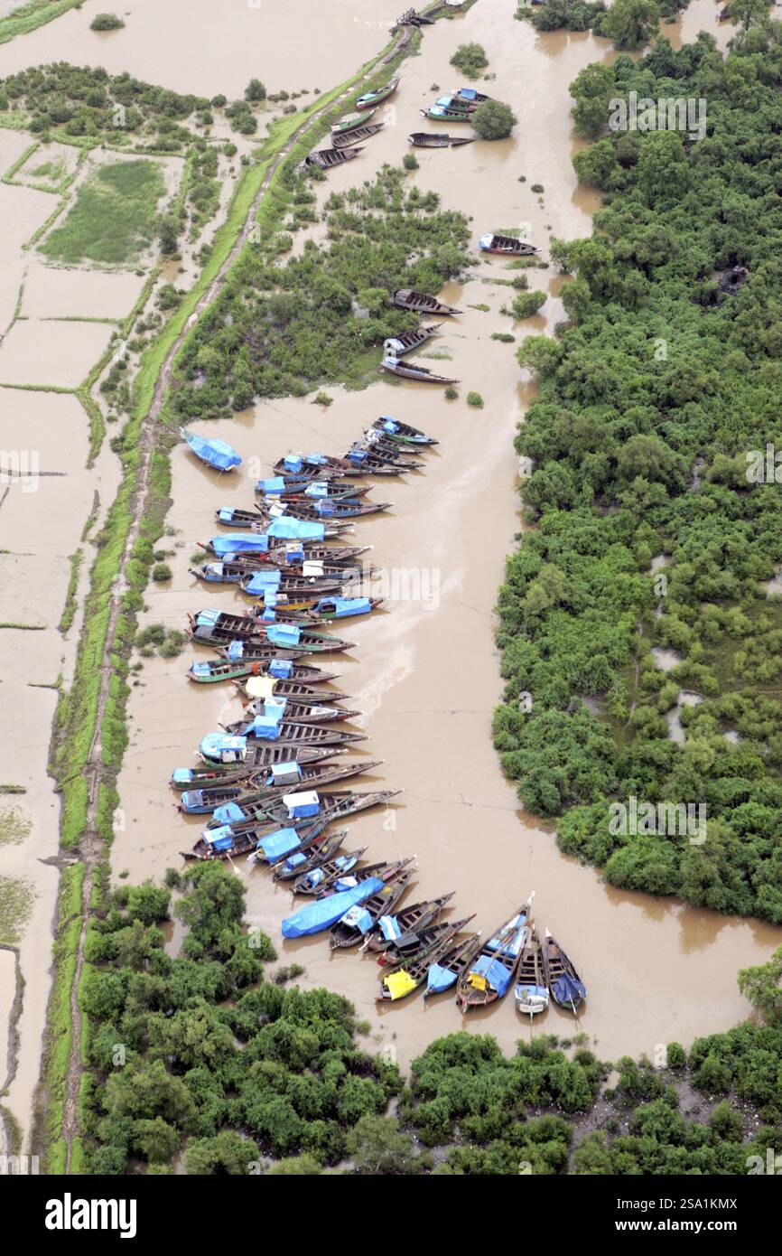 An aerial view of boats floating in water surround entire area flood ...