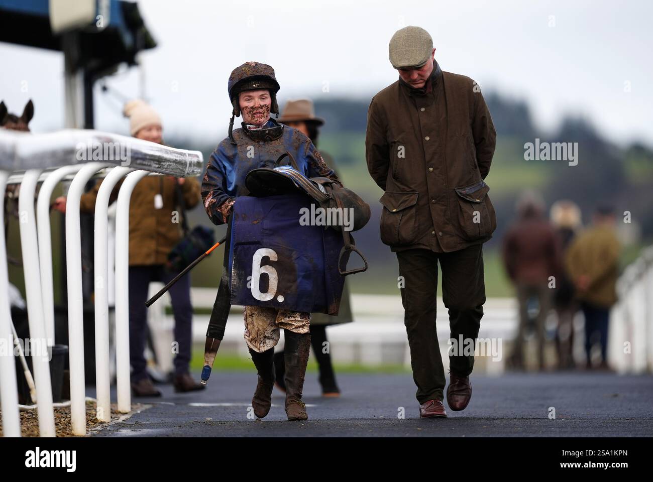 A muddy jockey Isabel Williams heads back in with trainer Evan Williams ...