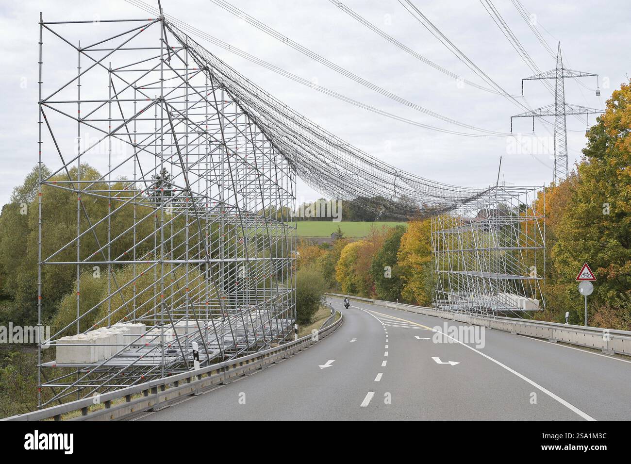 A scaffold with steel net as protection over a road, safety measure due ...