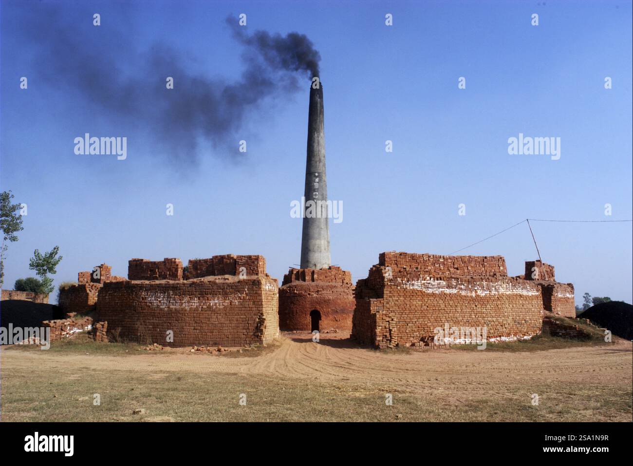 Smoke emitting out of chimney of brickyard, Village of Doulo Nangal in ...