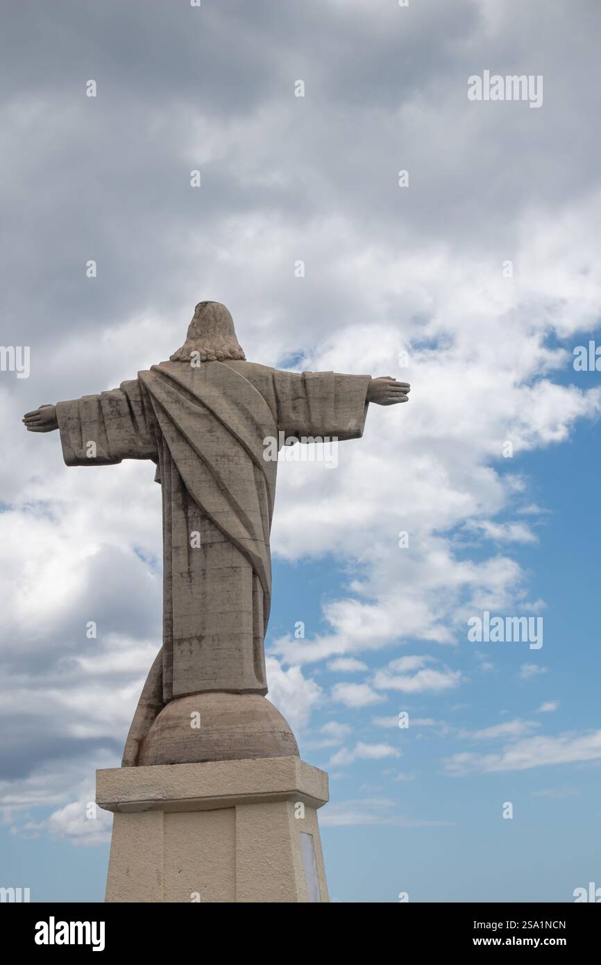 Monumental statue of Cristo Rei (Jesus Christ) on a hill at the coast ...