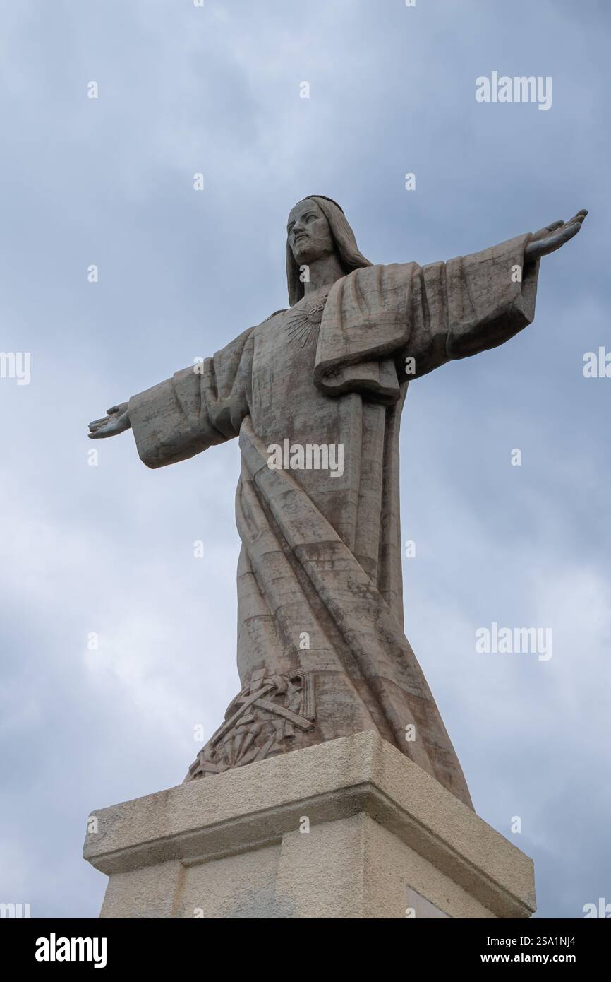 Monumental statue of Cristo Rei (Jesus Christ) on a hill at the coast ...
