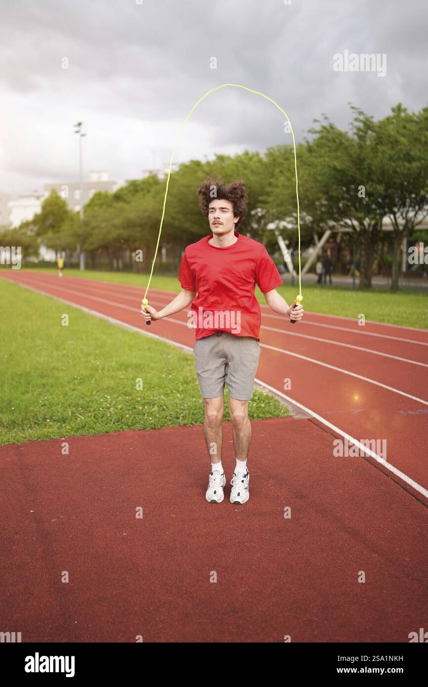 Vertical full length photo of a caucasian young male athlete jumping ...