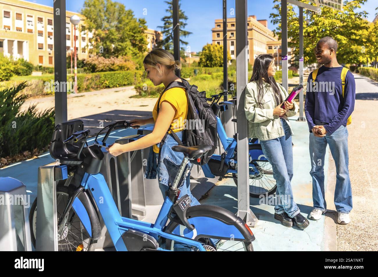 Side view full length photo of a young student using rental bike at ...