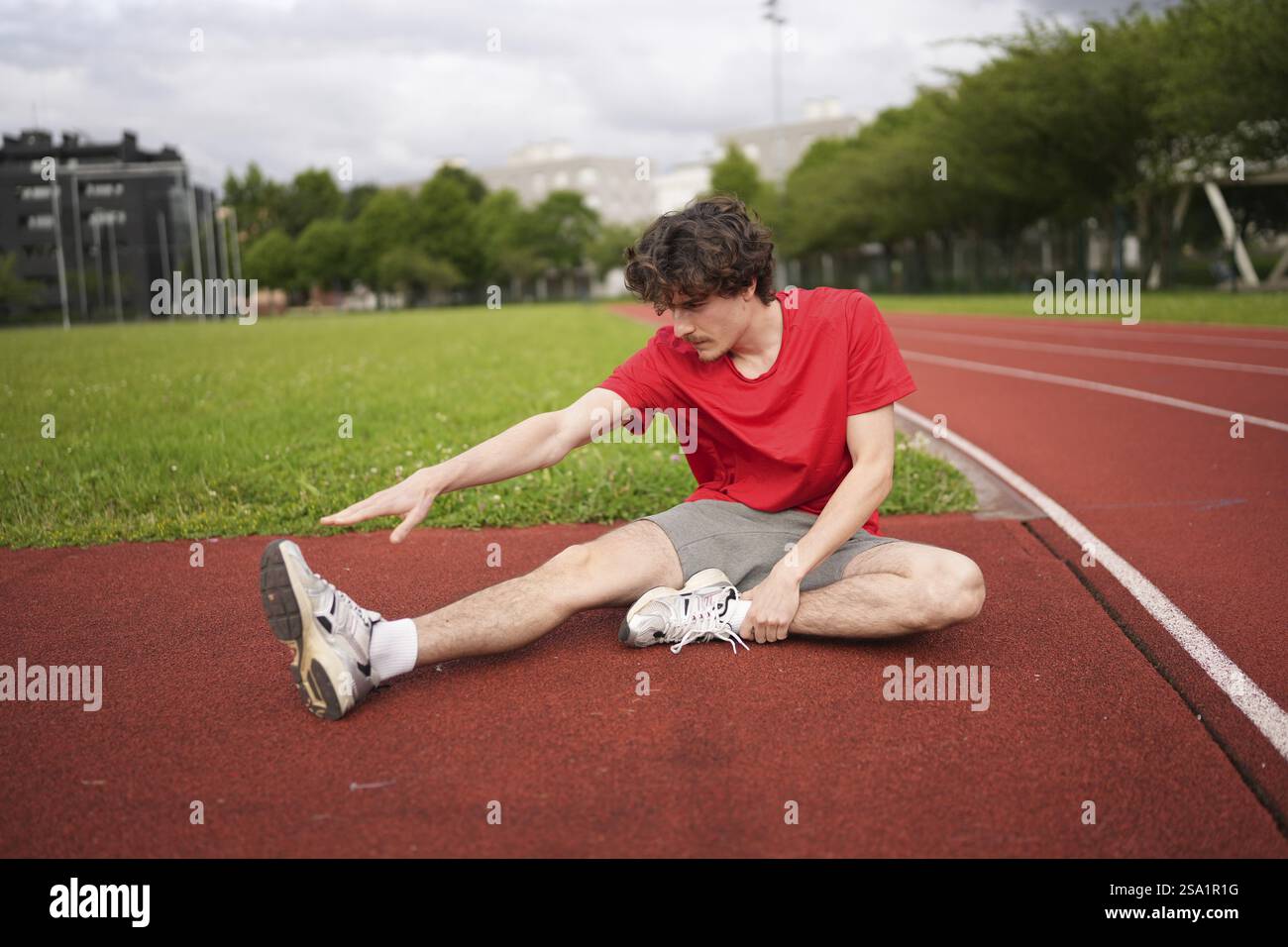 Full length photo of a caucasian young sportive man warming up ...