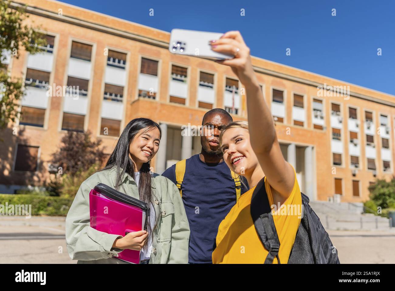 Frontal view of three male and females multi-ethnic university students ...