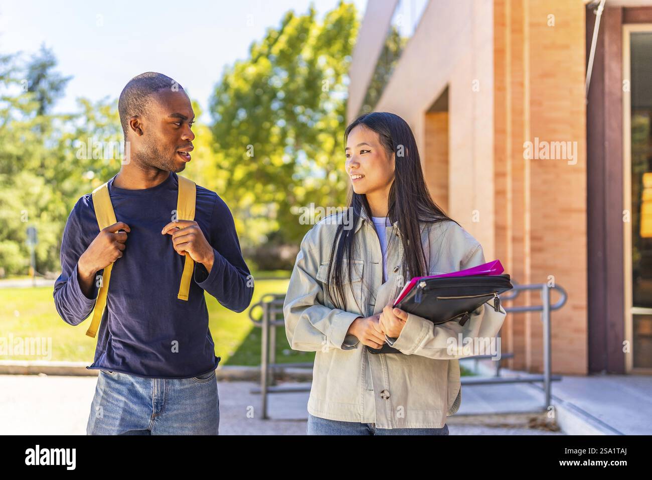 Multi-ethnic african and chinese exchange students talking walking ...