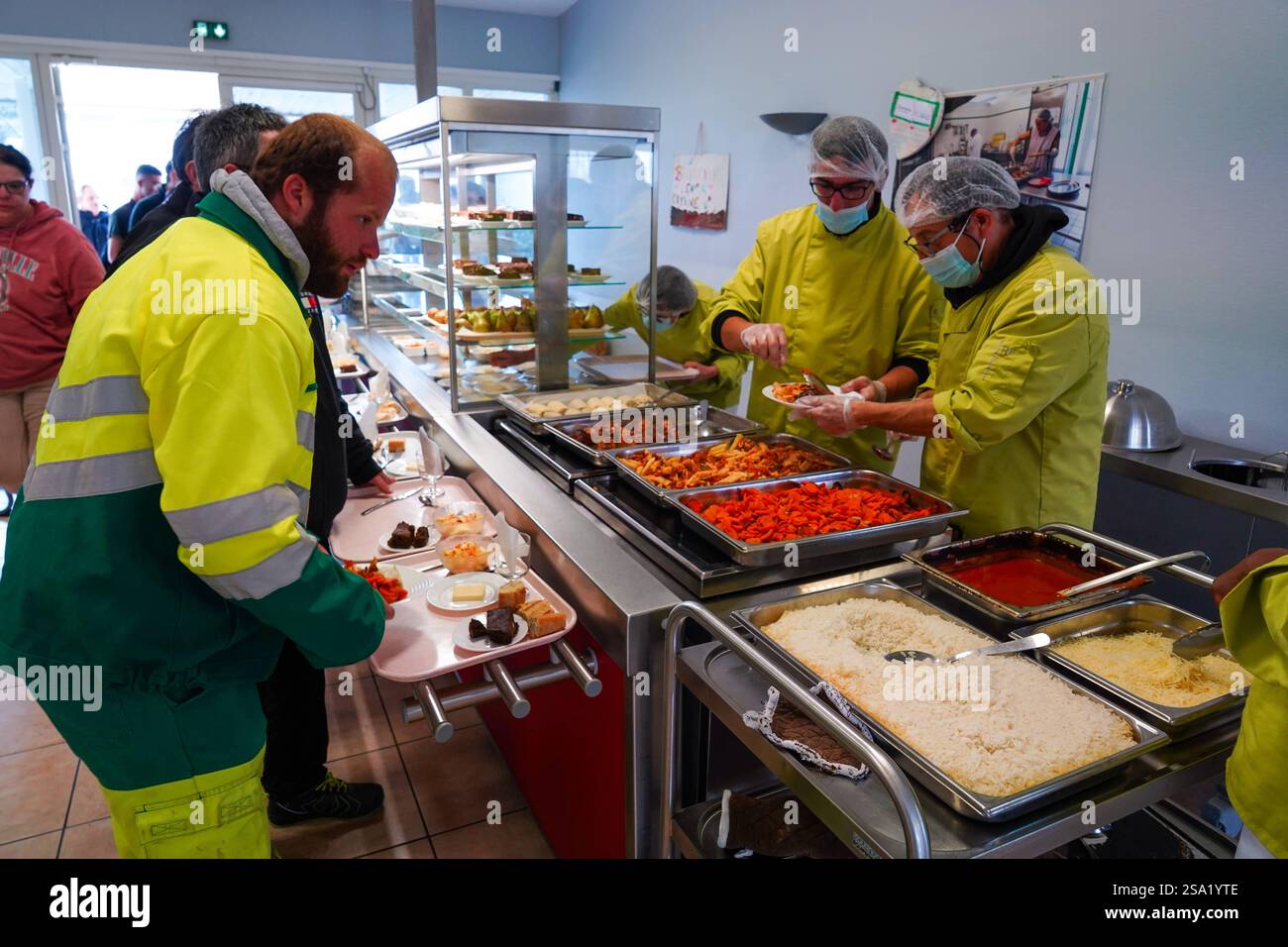 Disabled workers preparing meals for users and supervisors of the ESAT ...