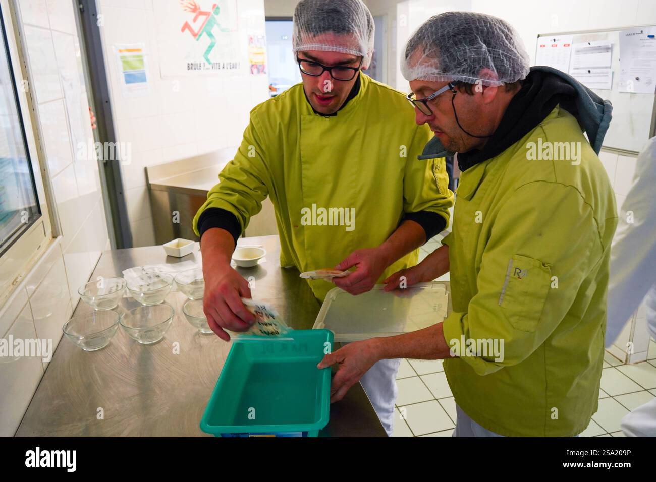 Disabled workers preparing meals for users and supervisors of the ESAT ...
