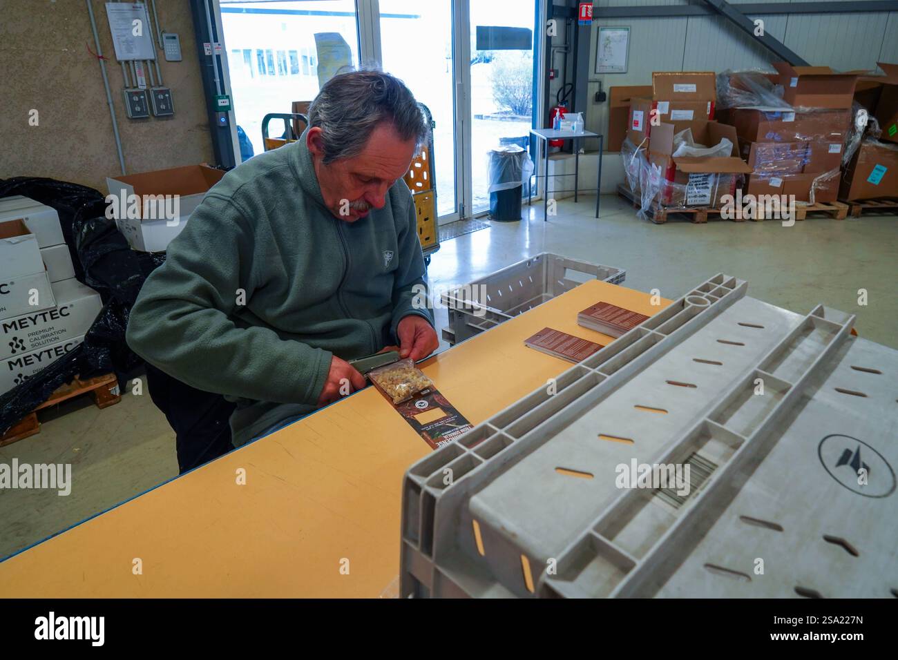 Disabled worker working in the ESAT product packaging workshop ...