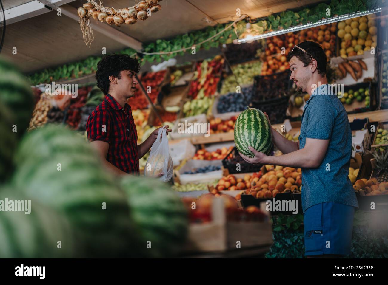 Friends shopping for fresh fruits and vegetables at a local greengrocer ...