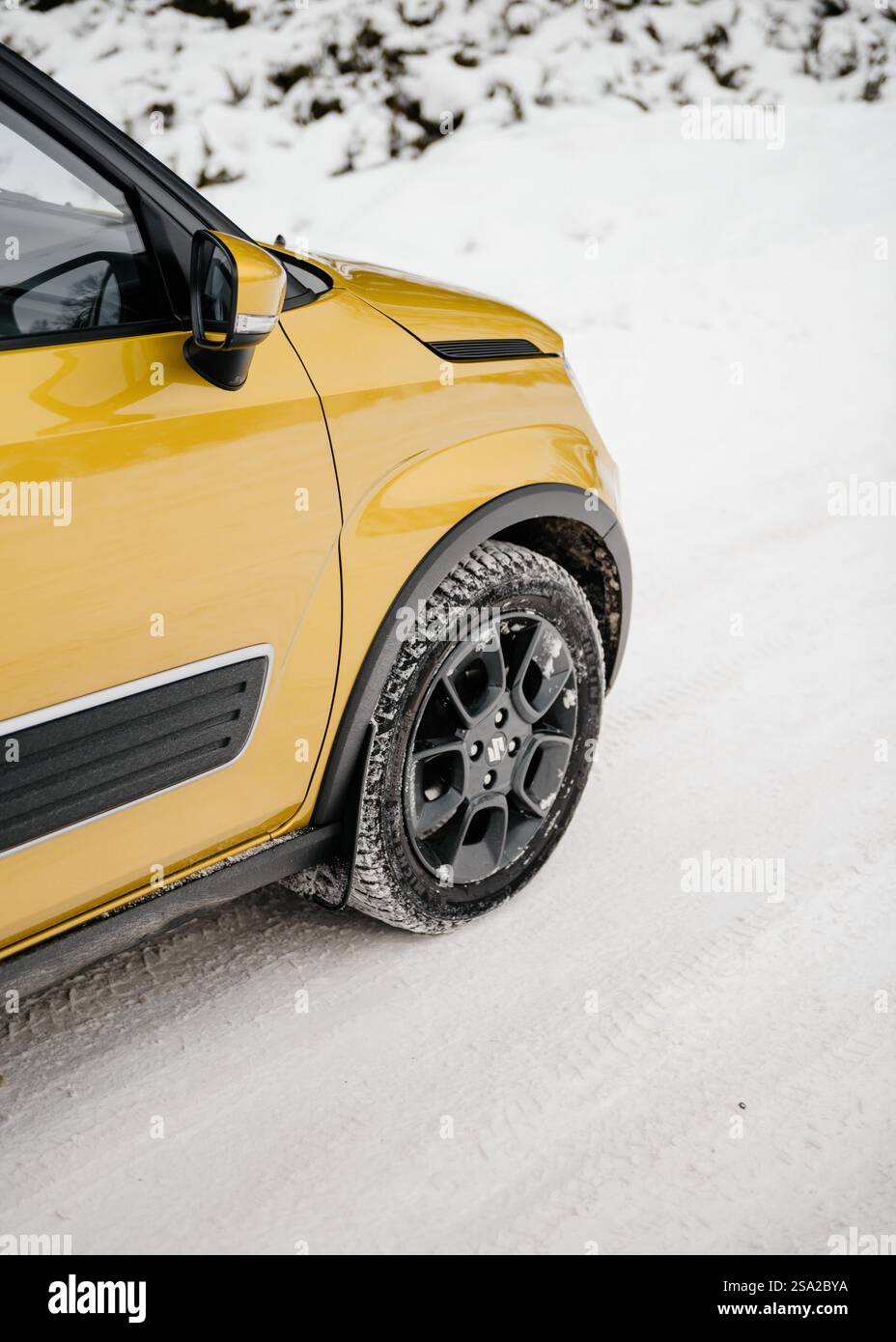 Golden Suzuki Ignis on snow. Front fender view of japanese compact ...