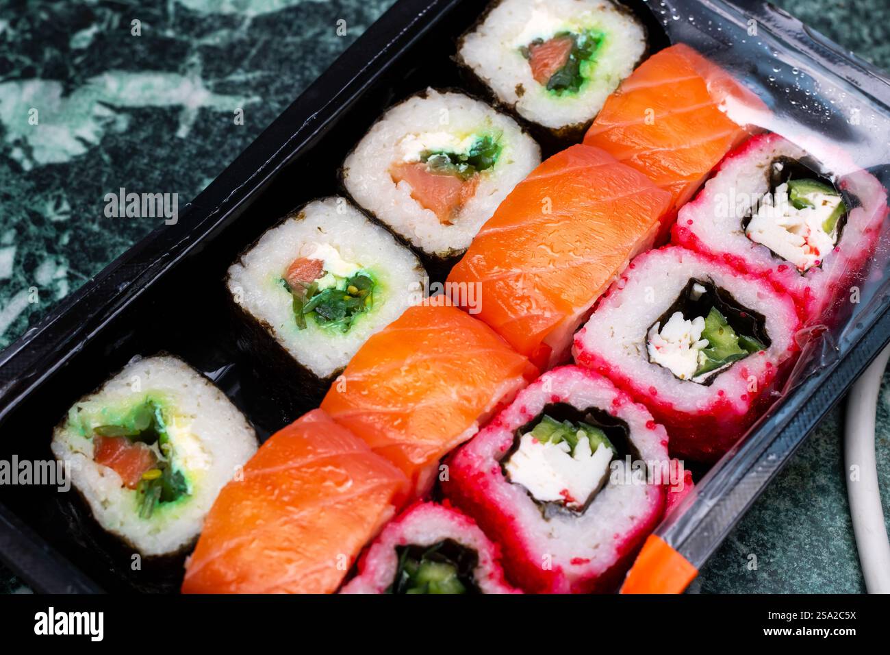 A bright and colorful plastic container is filled with an assortment of ...