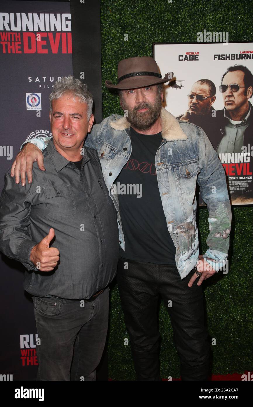 Guest and Nicolas Cage at the 'Running with the Devil' film premiere ...