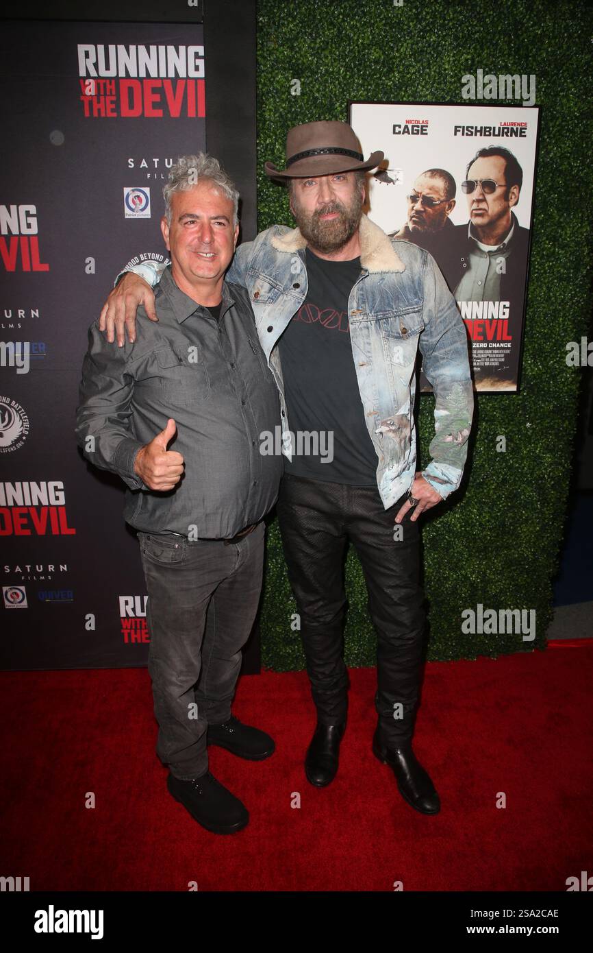 Guest and Nicolas Cage at the 'Running with the Devil' film premiere ...