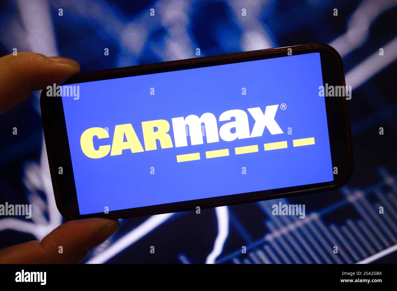 In this photo illustration, the CarMax company logo is seen displayed ...
