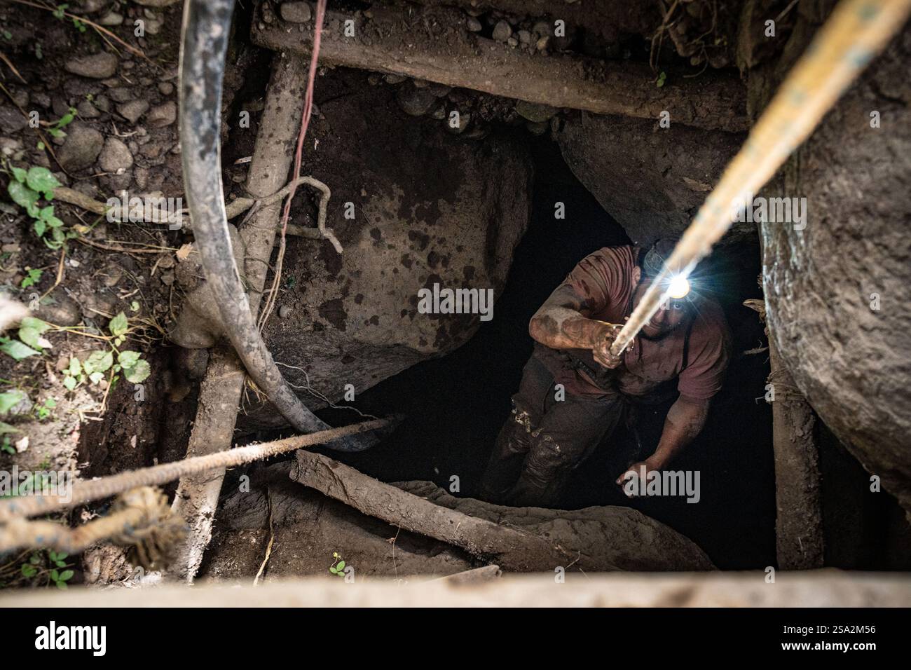 Supia, Colombia. 24th Jan, 2025. A miner enters an illegal artisanal ...