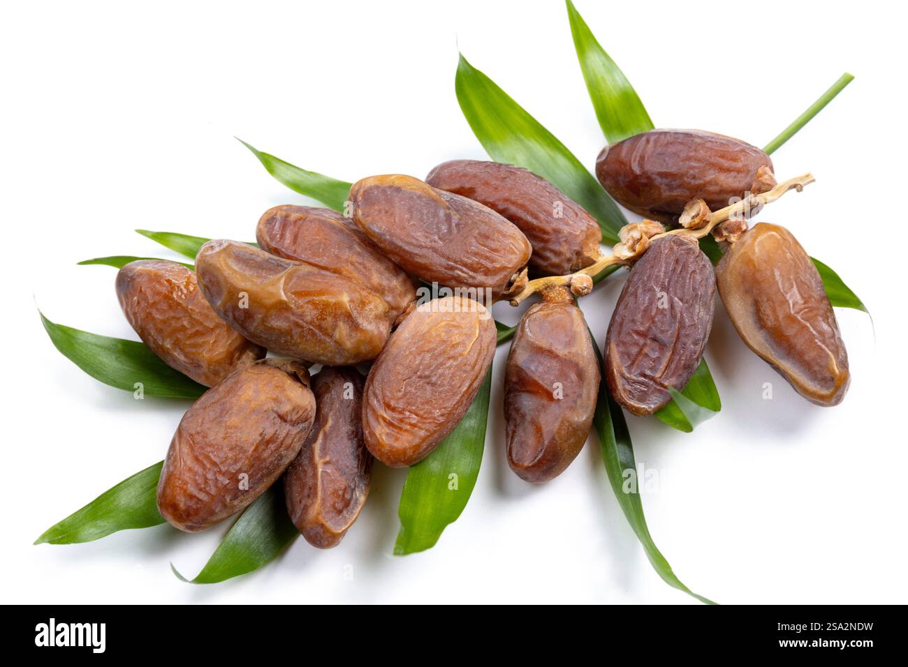 Dates on a branch on a palm leaf Stock Photo - Alamy