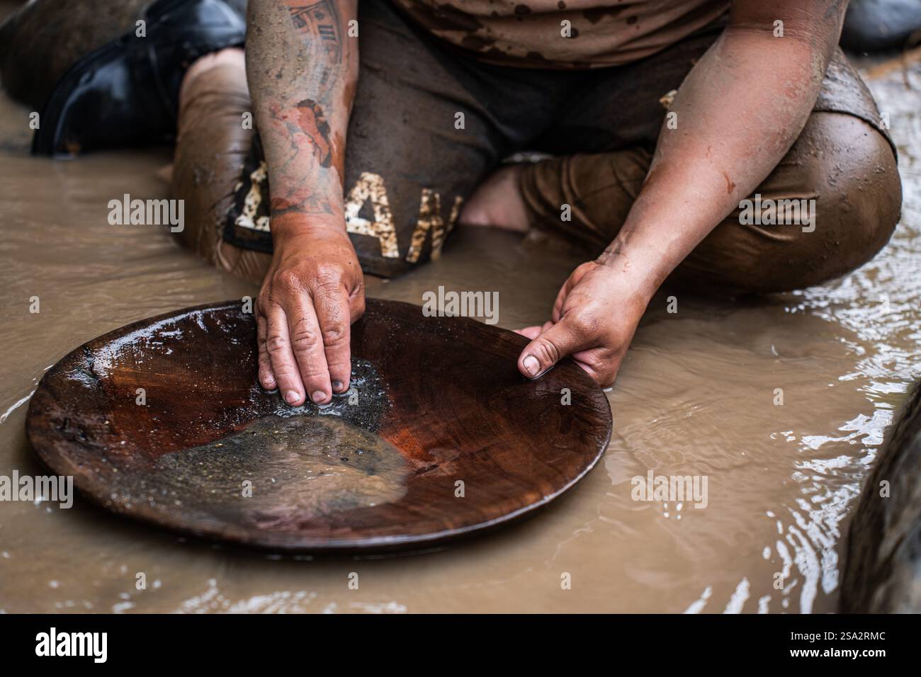 Supia, Colombia. 24th Jan, 2025. A miner carefully washes the material ...