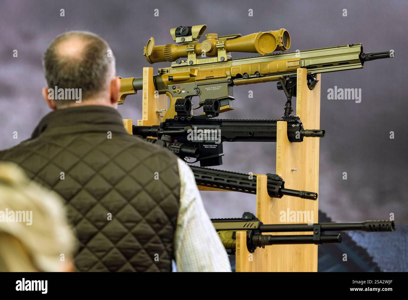A visitor watches hunting rifles at the hunting show in Dortmund ...