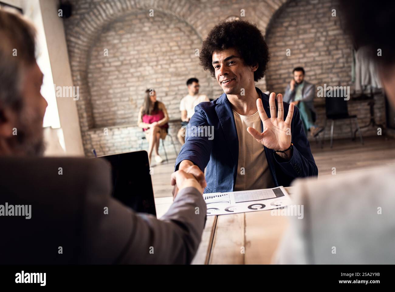 Business recruiters shakes hands with candidate during job interview ...