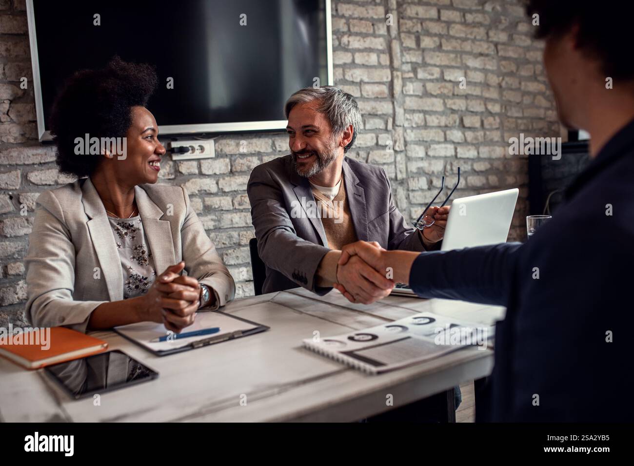 Business recruiters shakes hands with candidate during job interview ...