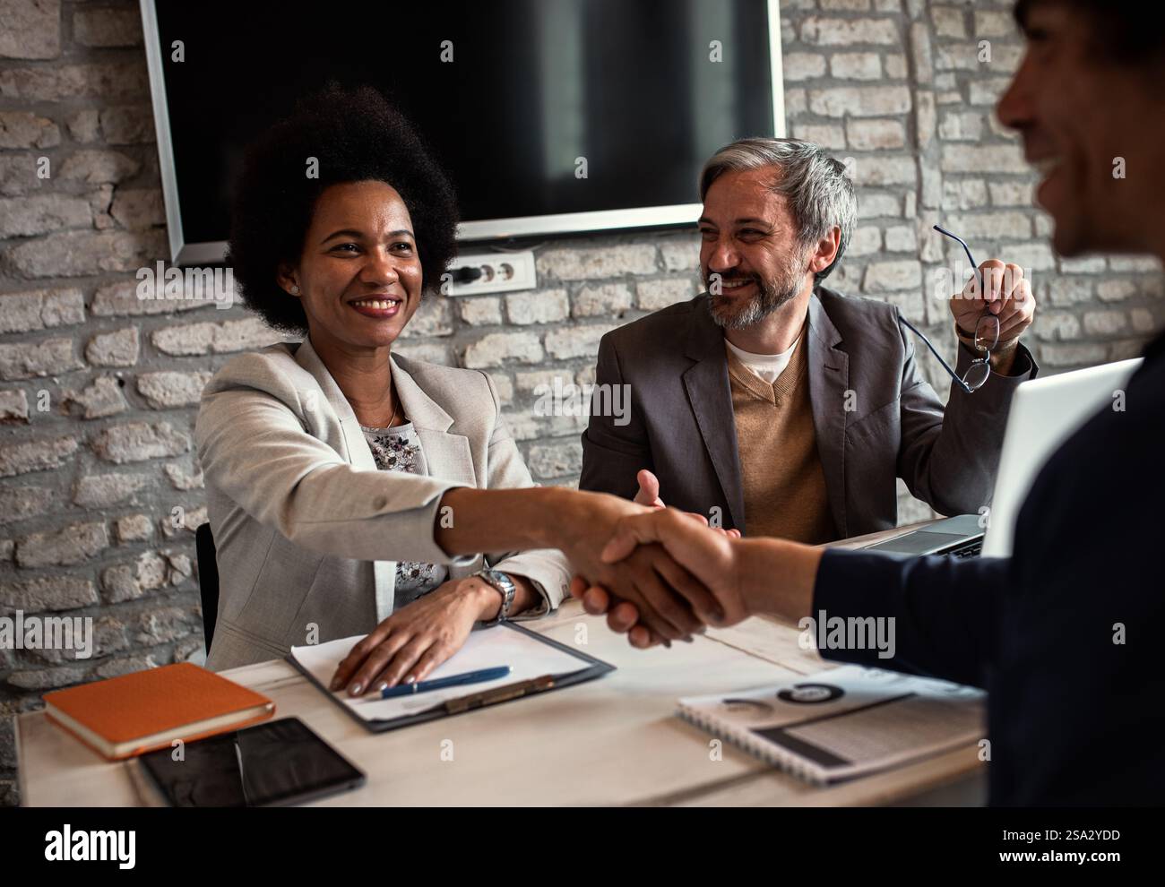 Business recruiters shakes hands with candidate during job interview ...