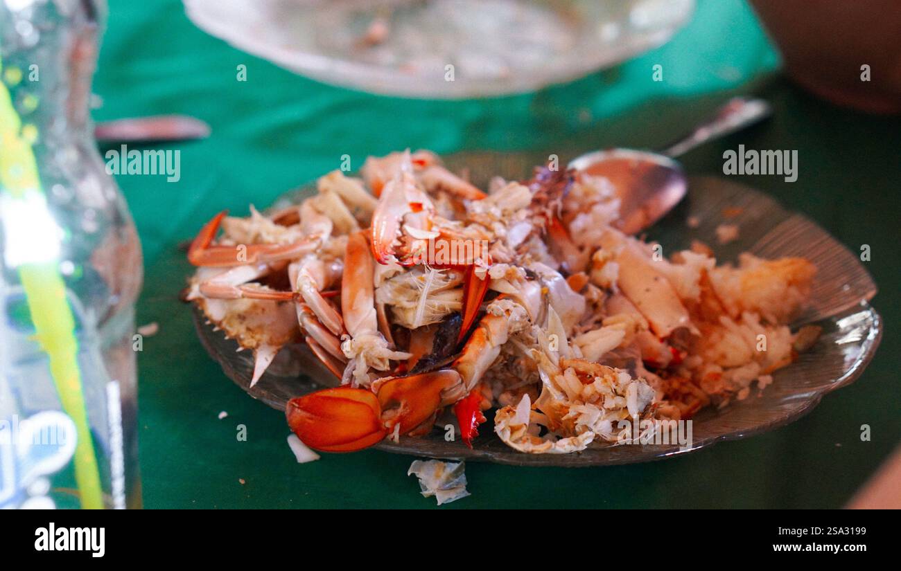 A feast of crabs all cracked and peeled, leaving behind a pile of empty ...