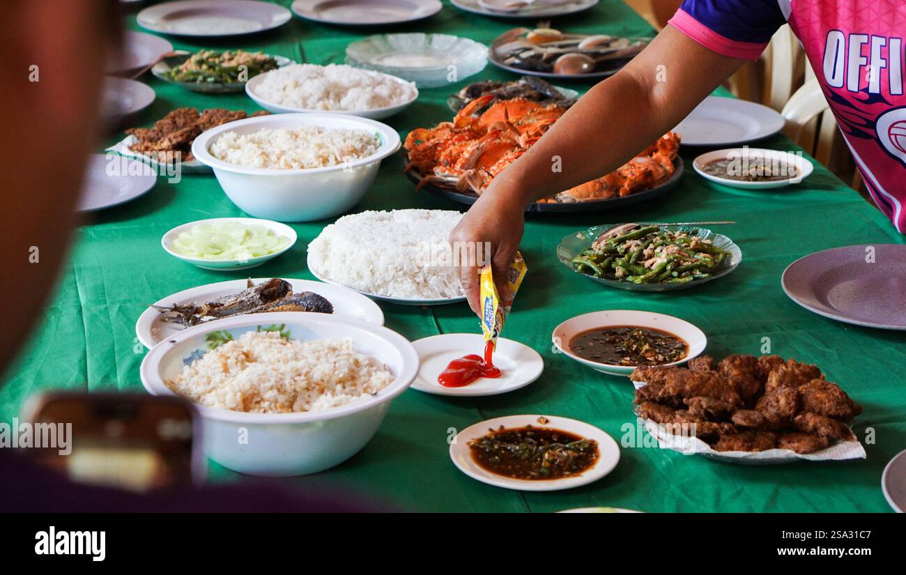 A vibrant crab feast preparation in a Filipino village, featuring a ...