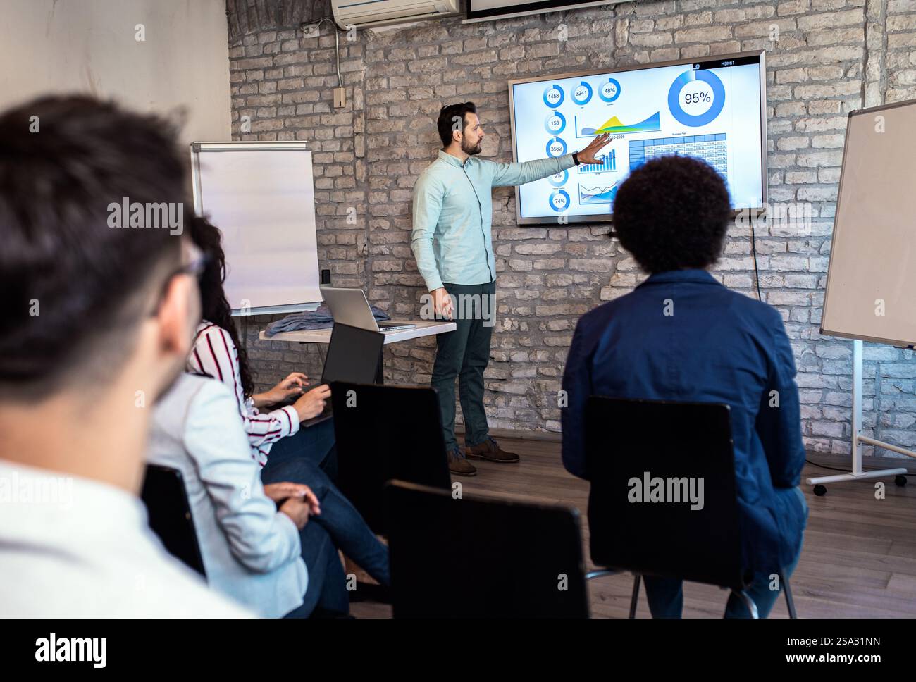 Businessman holding presentation to diverse group of people Stock Photo ...