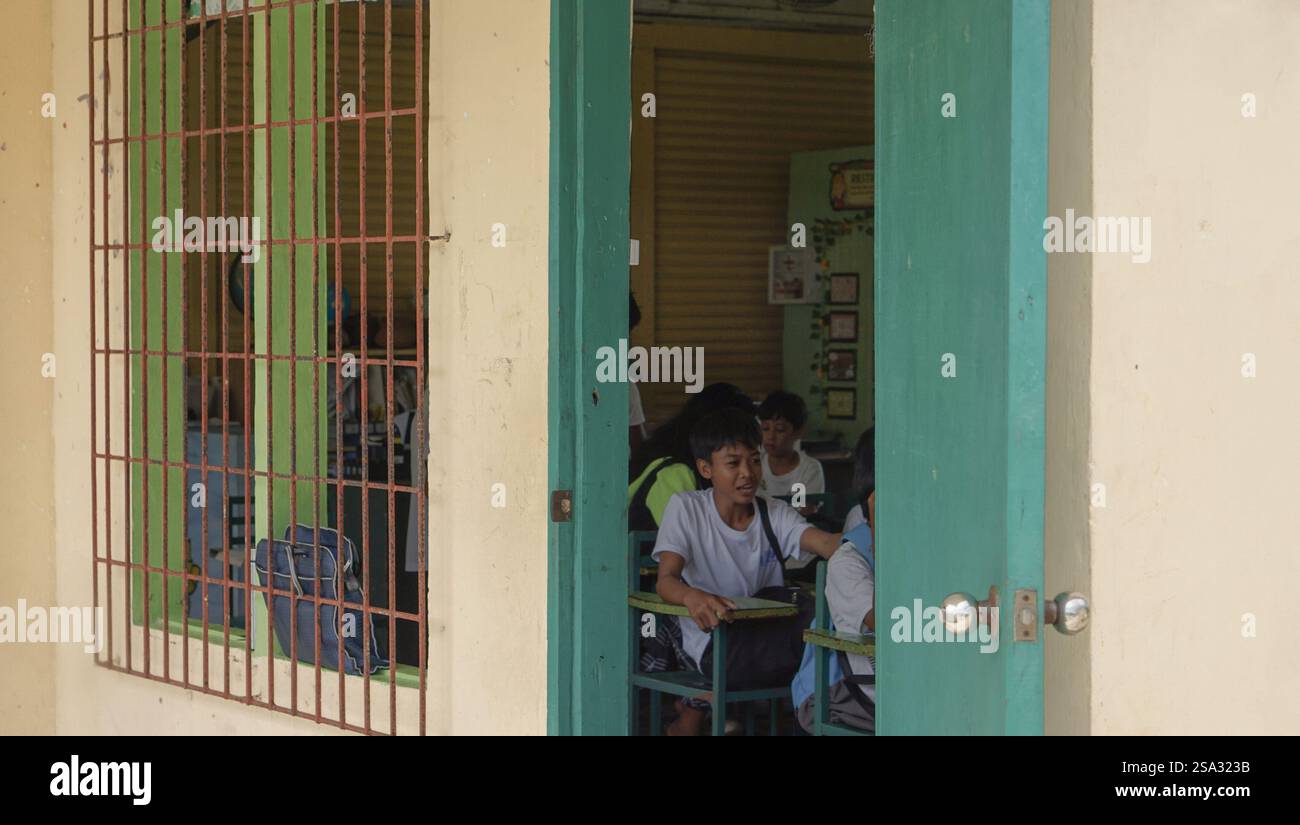 A village classroom in Iloilo, Philippines, seen through an open door ...
