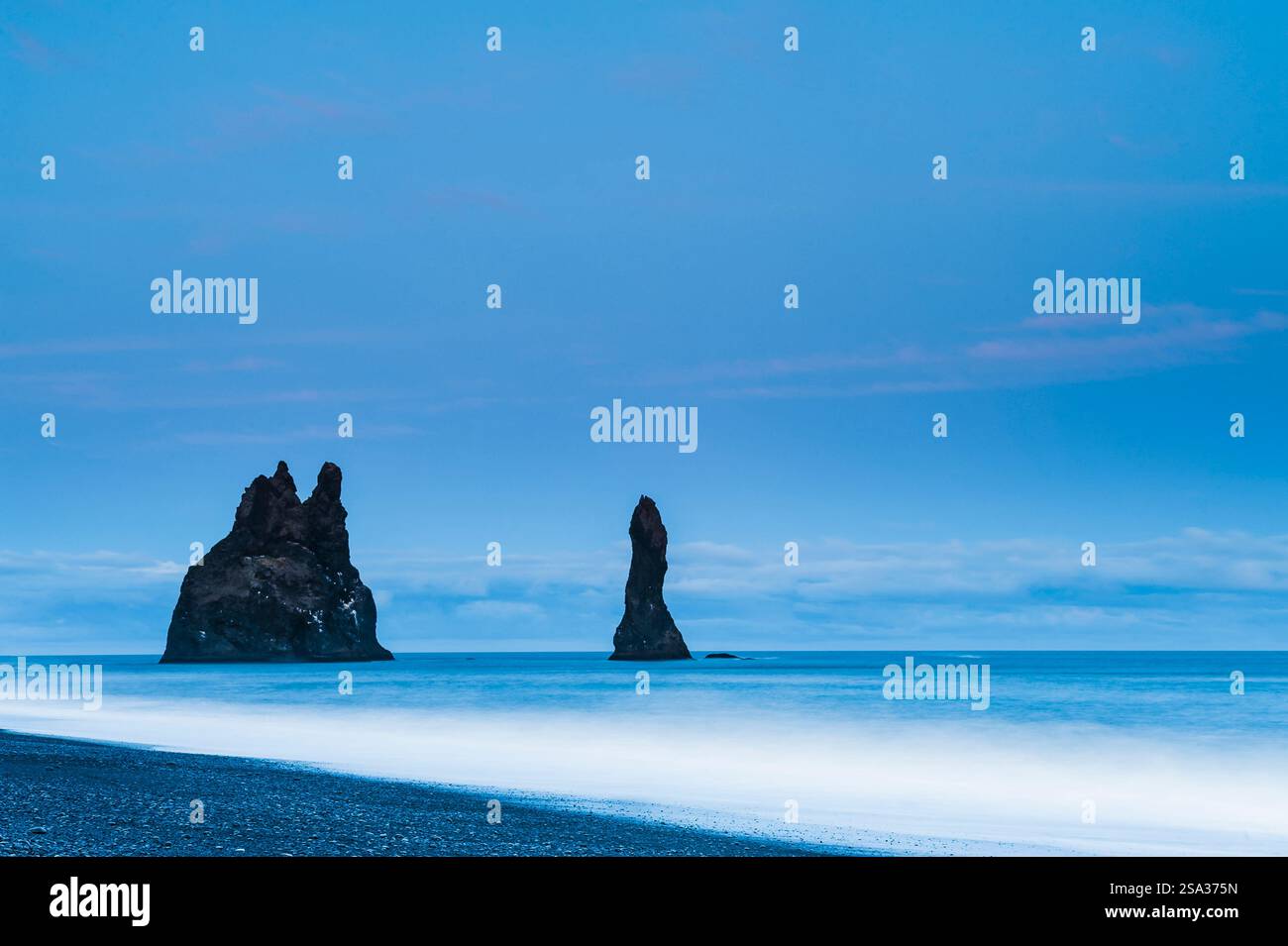 This breathtaking coastal view showcases iconic rock formations rising from the calm ocean ...